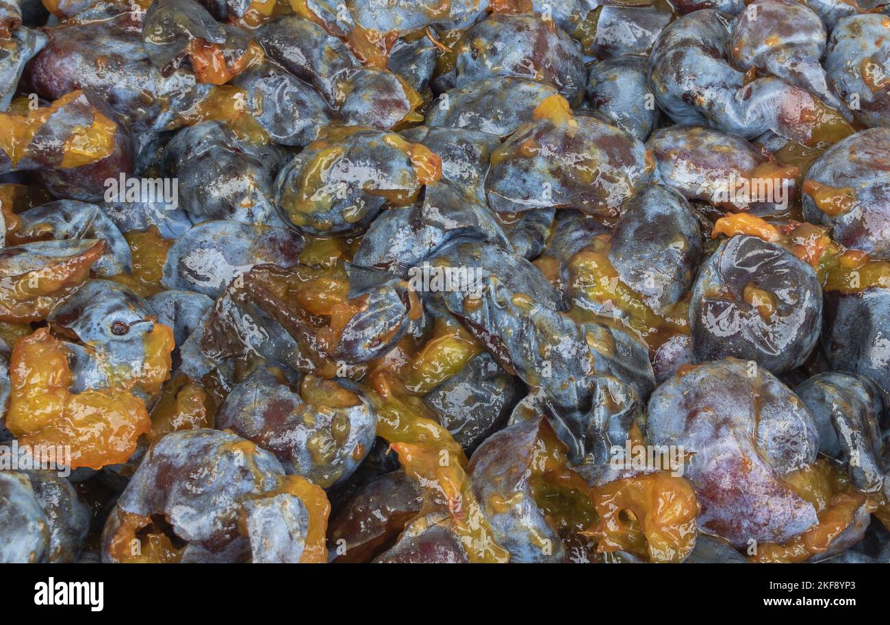 A lot of plums with pits removed texture - in the process of cooking ...