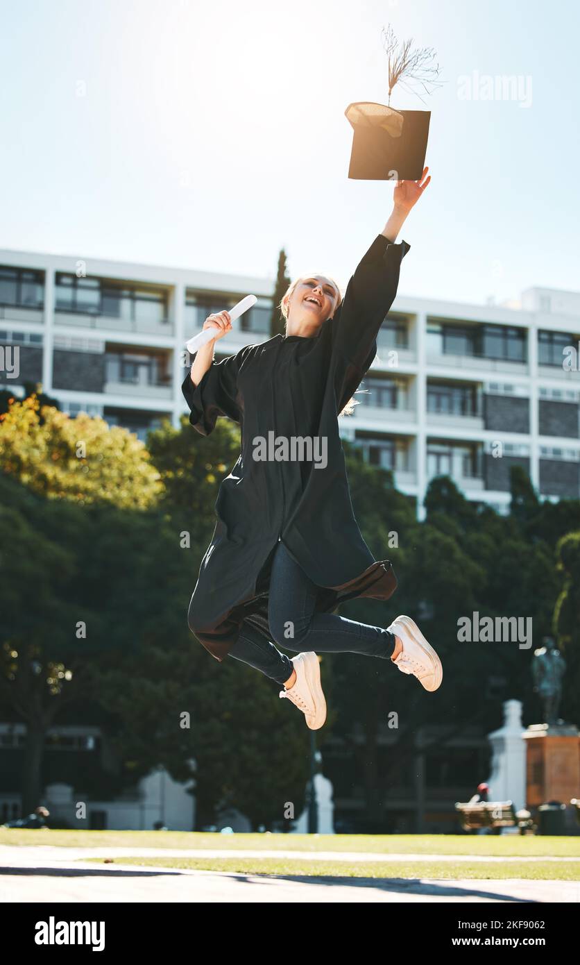 Woman graduation, jump and celebrate at college, school or university ...