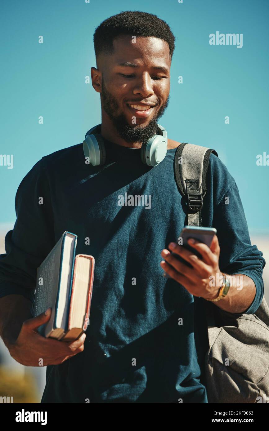 Social media, student and black man with a phone at a college for ...