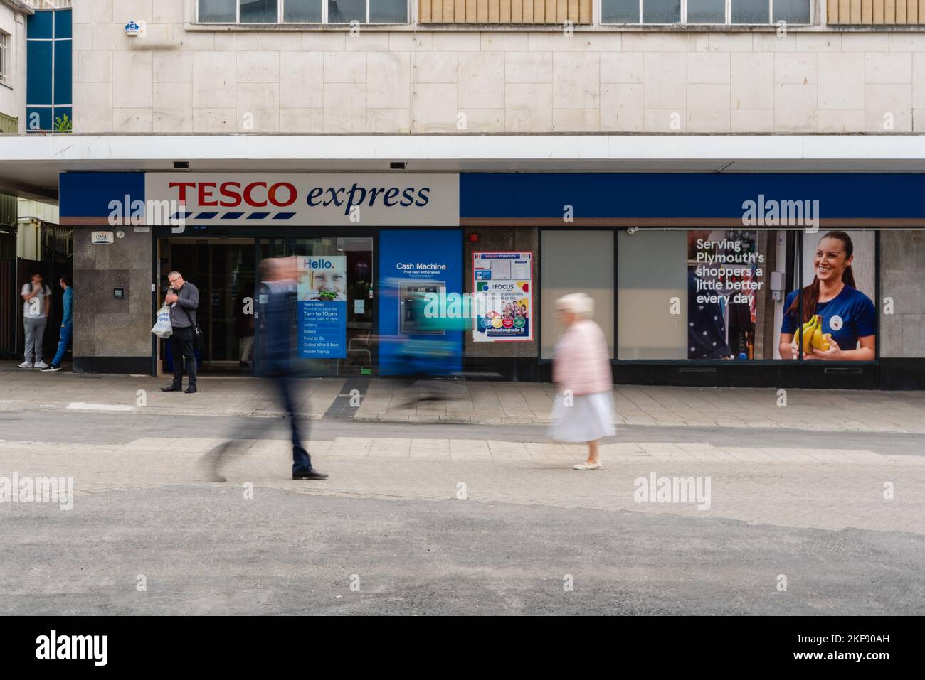 A group of people with long exposure rushing near the Tesco Express ...