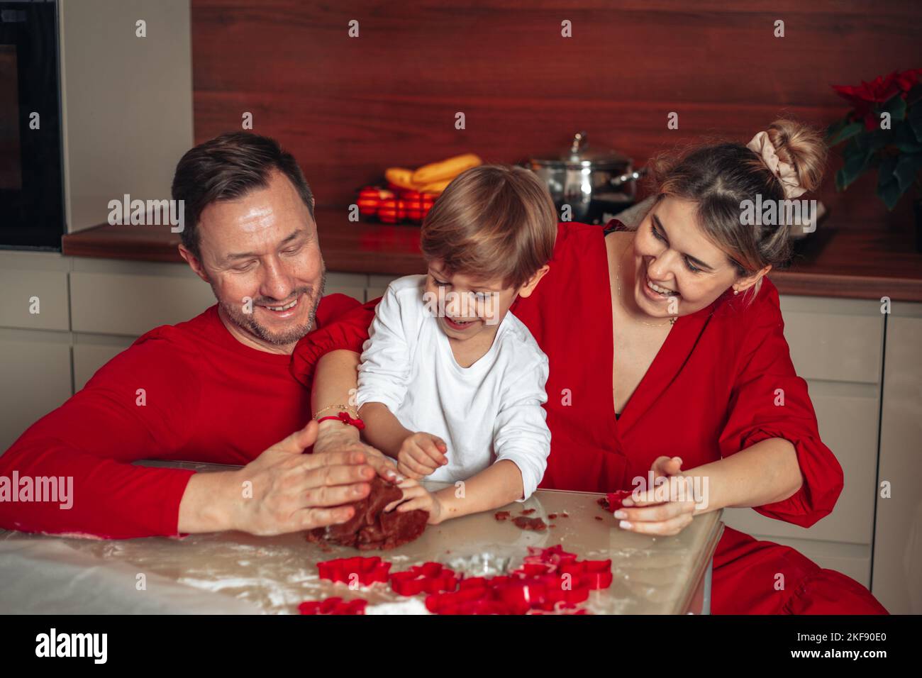 Father, mother and son are Busy with Joint baking. Bake Christmas ...