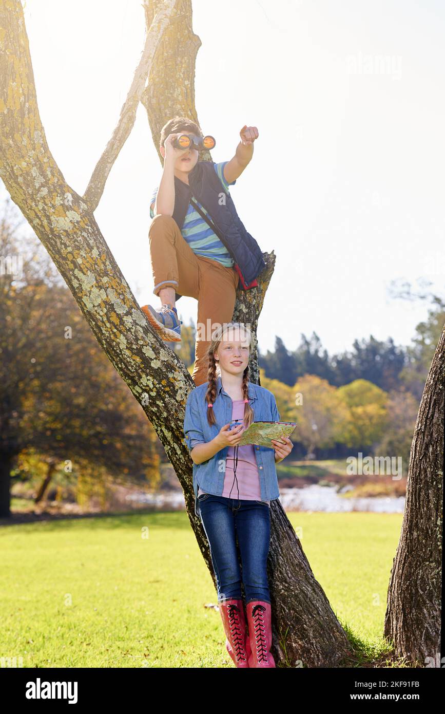 Intrepid explorers. Two young friends with binoculars and a map ...