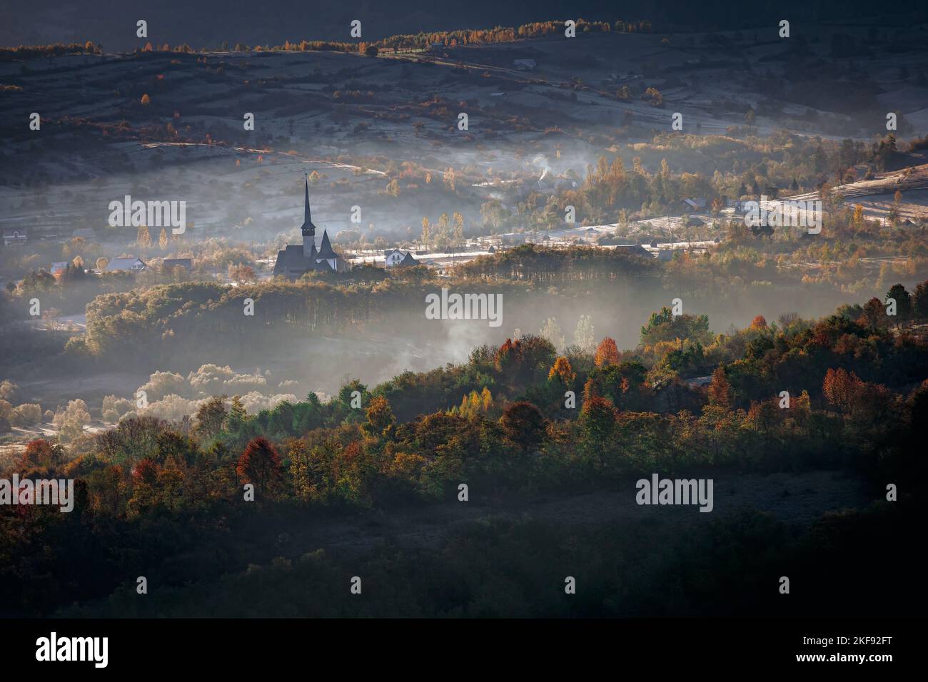 Dramatic autumn morning above the Ieud village in the historical region ...