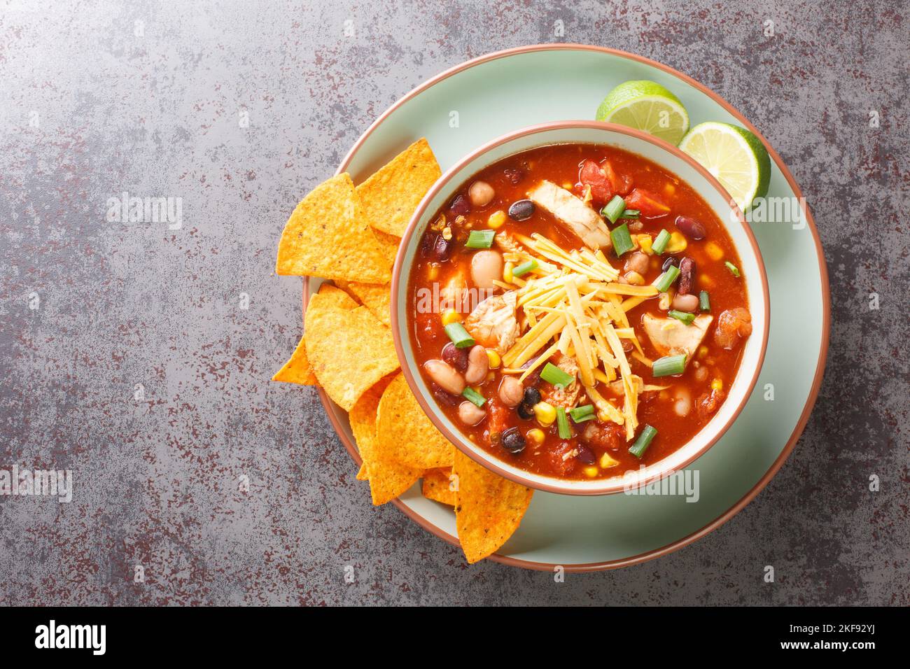 Chicken taco soup cooked in fragrant broth with beans, corn, tomatoes ...