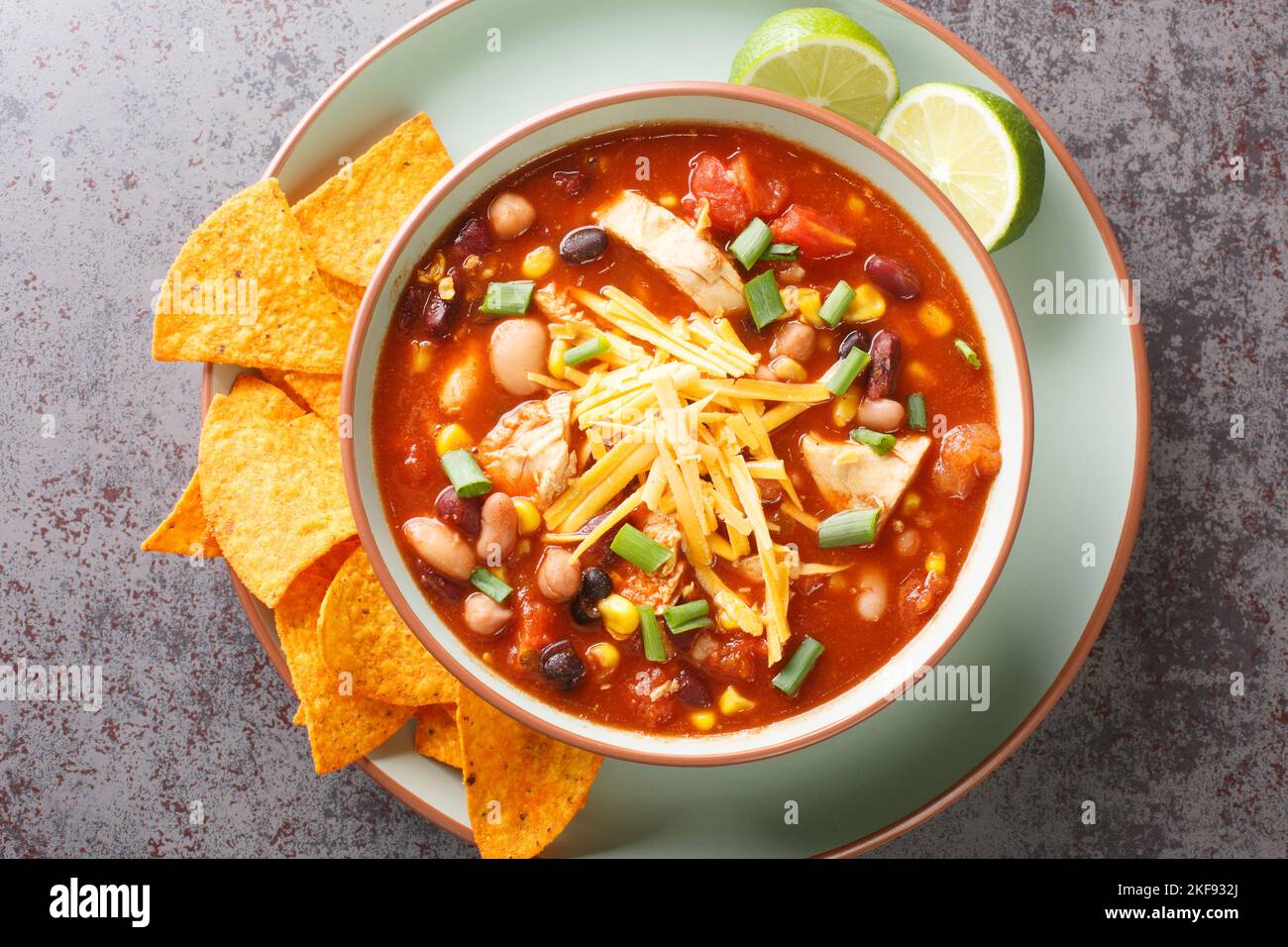 Chicken Taco Soup with black bean, corn kernels, tomatoes topped with ...