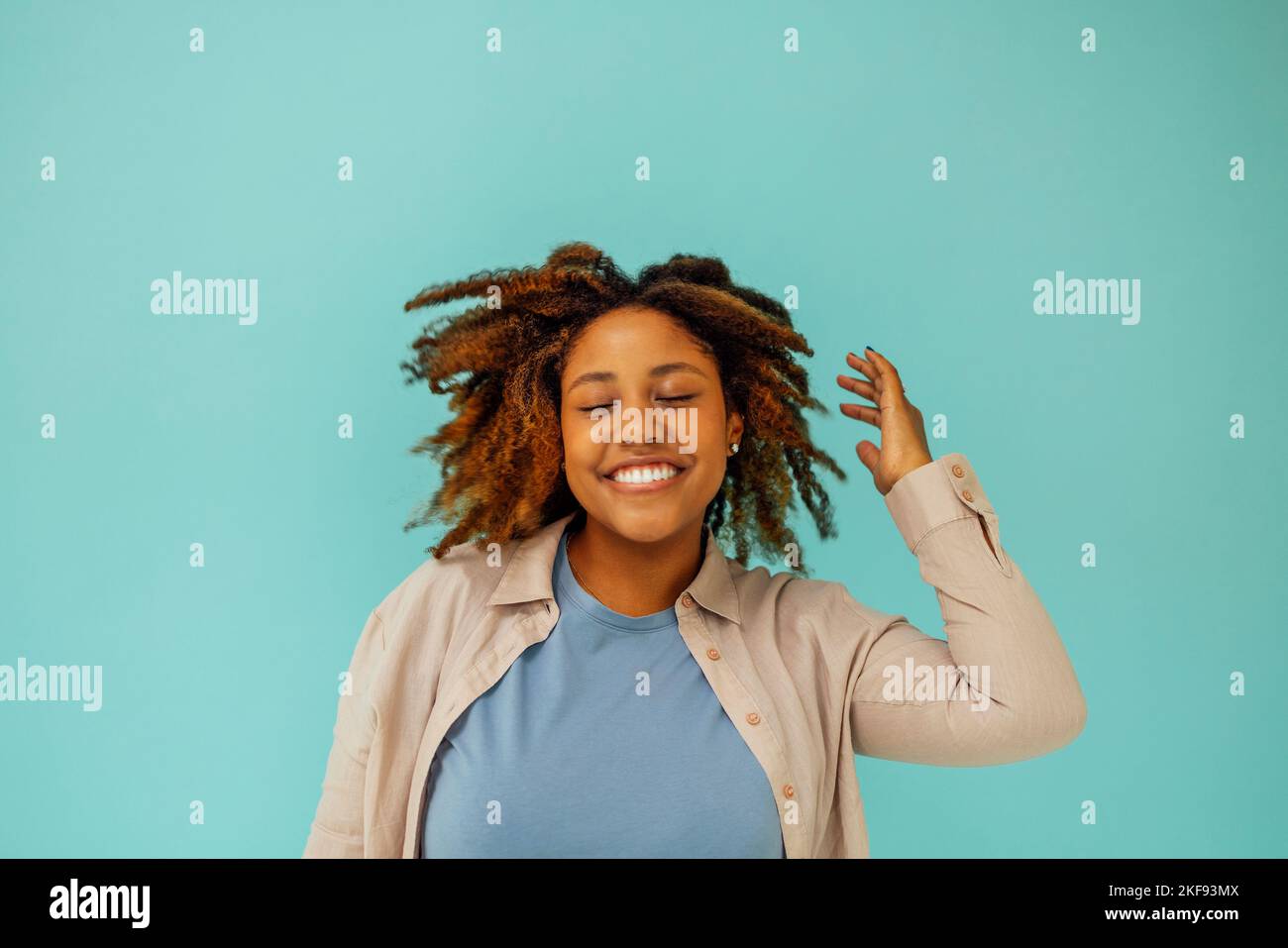Cheerful good looking carefree young african american woman showing ...