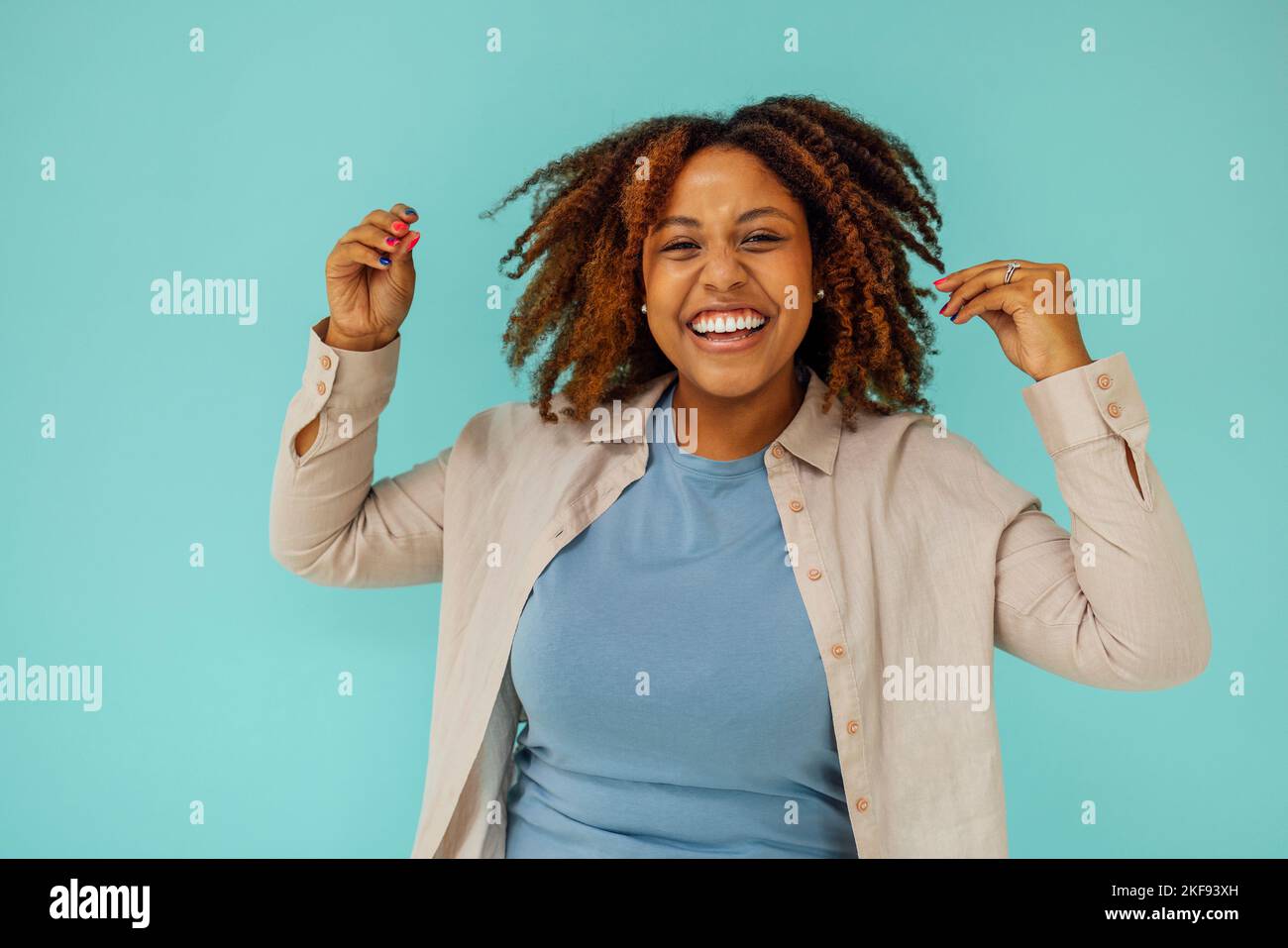 Cheerful good looking carefree young african american woman showing ...