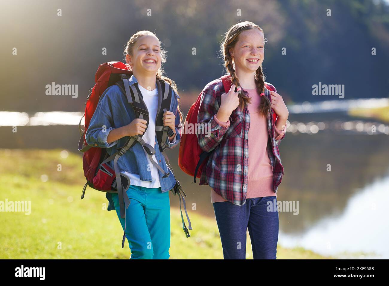Cant wait to get to the campsite. two young girls wearing backpacks ...