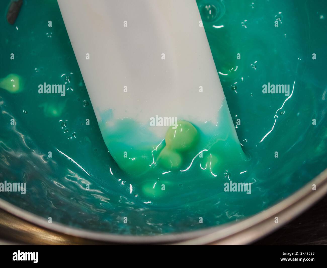 melting piping bag light blue turquoise green filling to drip a frosted ...