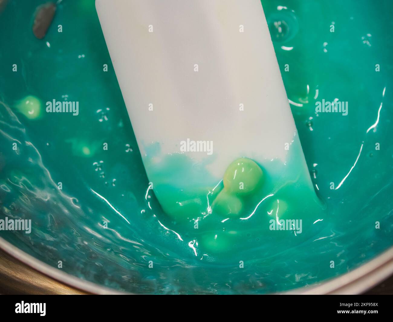 melting piping bag light blue turquoise green filling to drip a frosted ...