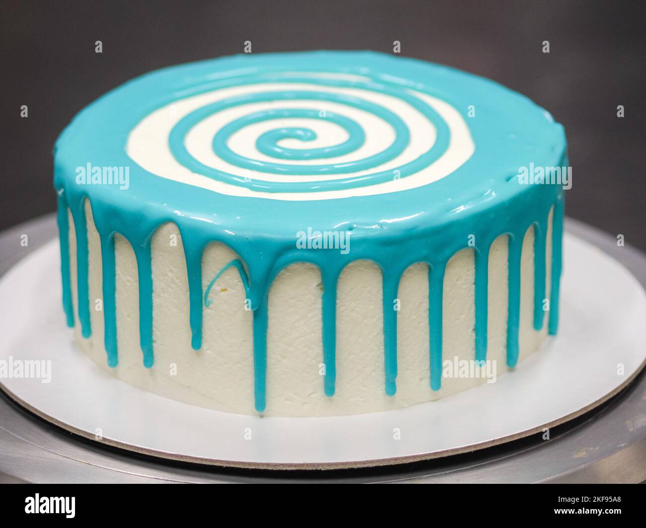 pastry chef cake designer decorating turquoise blue white frosted ...