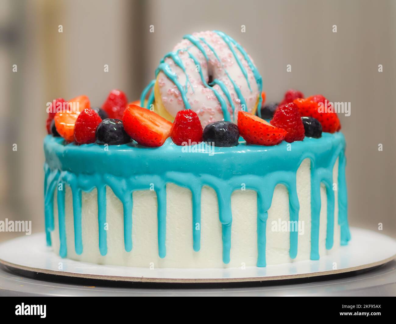 pastry chef cake designer decorating turquoise blue white frosted ...