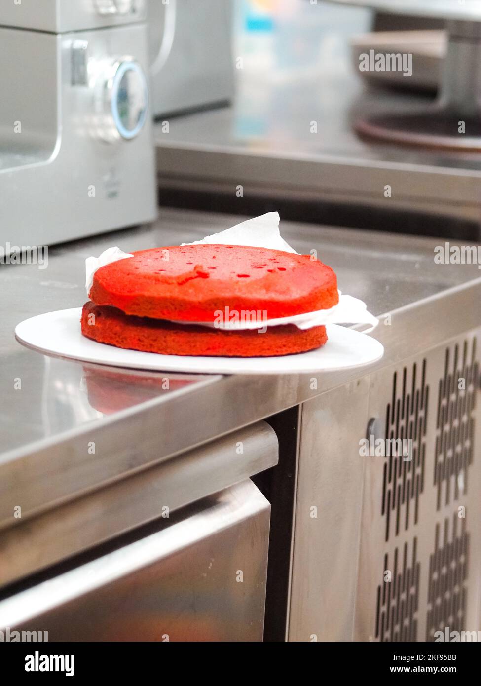 Chef cake designer preparing layered creamy cake base for frosted ...
