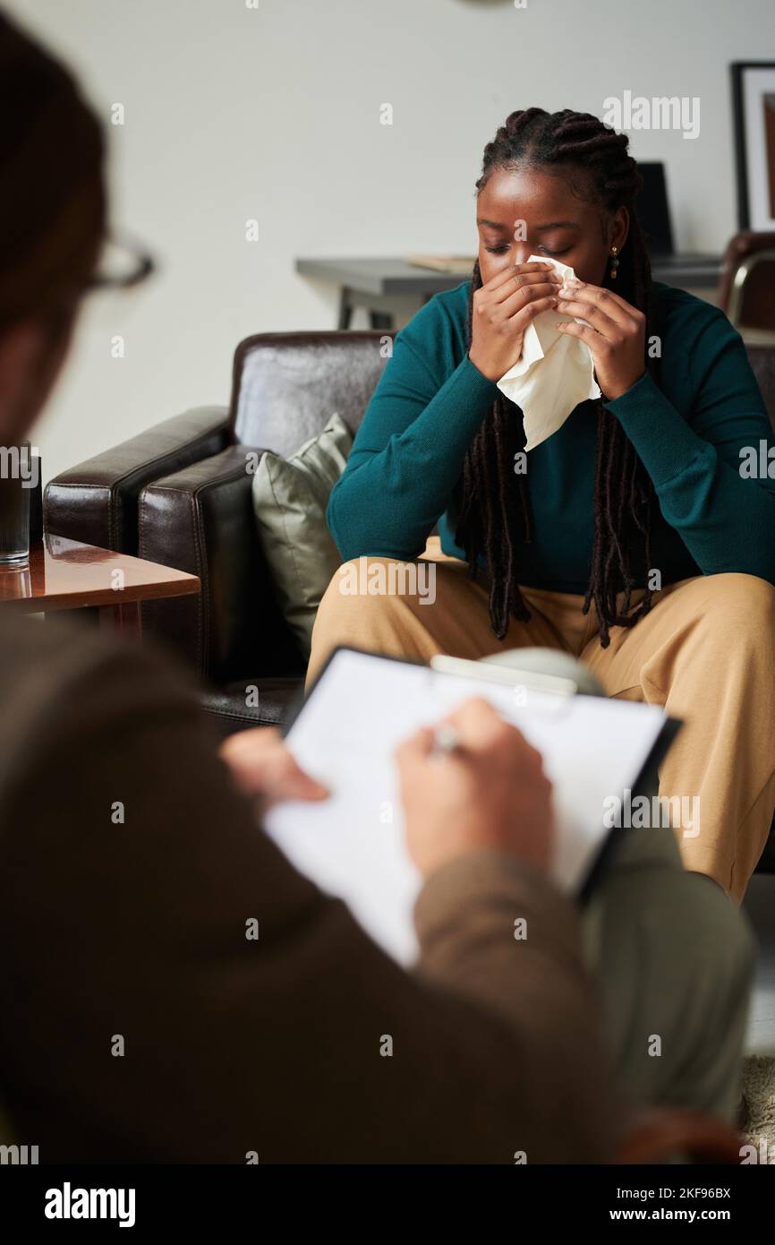 African American sad patient wiping her face with tissue, she crying ...