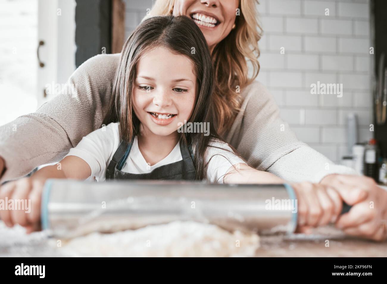 Happy, kitchen and mother baking with her child for a celebration ...