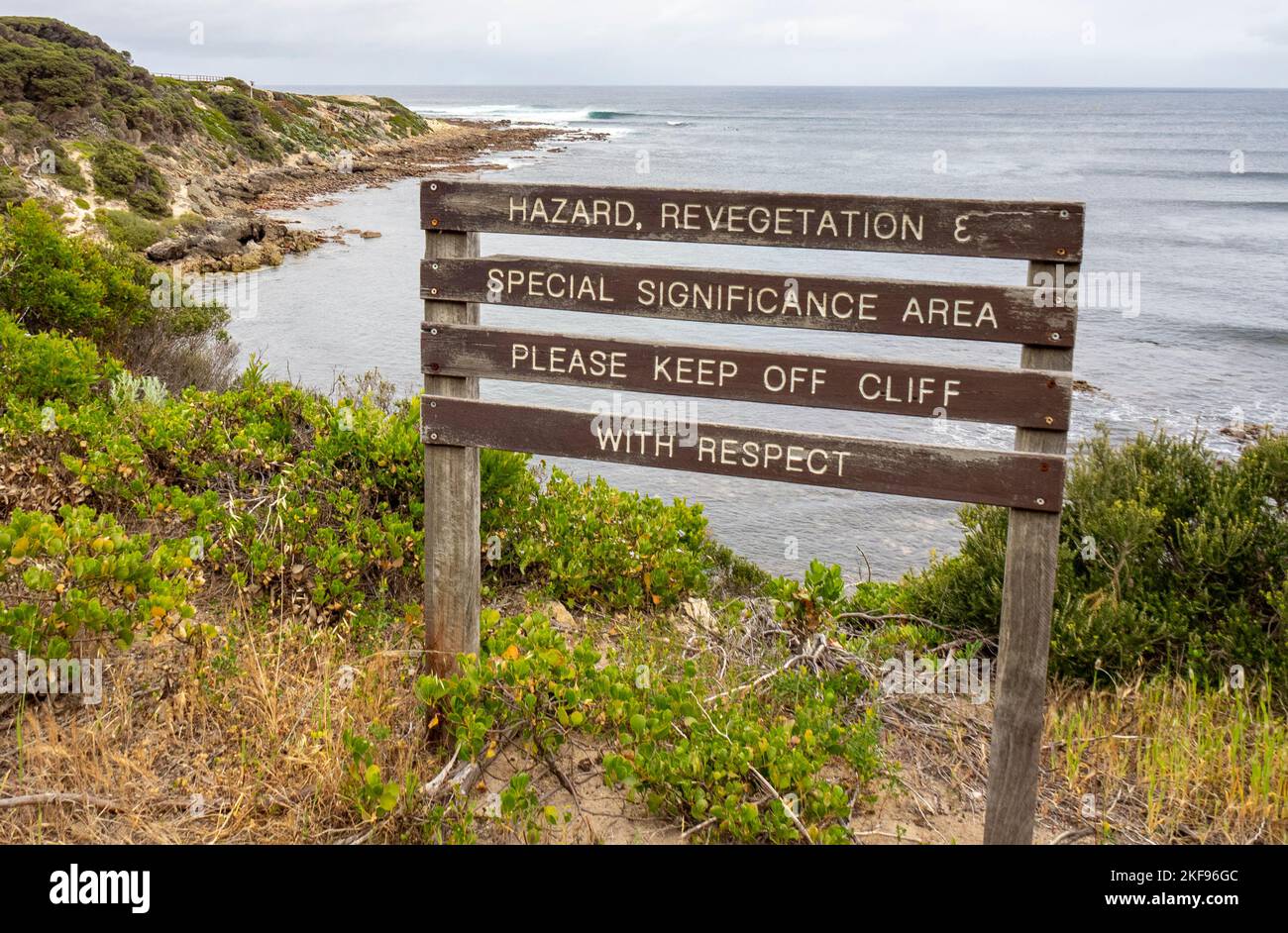 Wooden sign warning of danger near cliff on the Cape to Cape trail ...