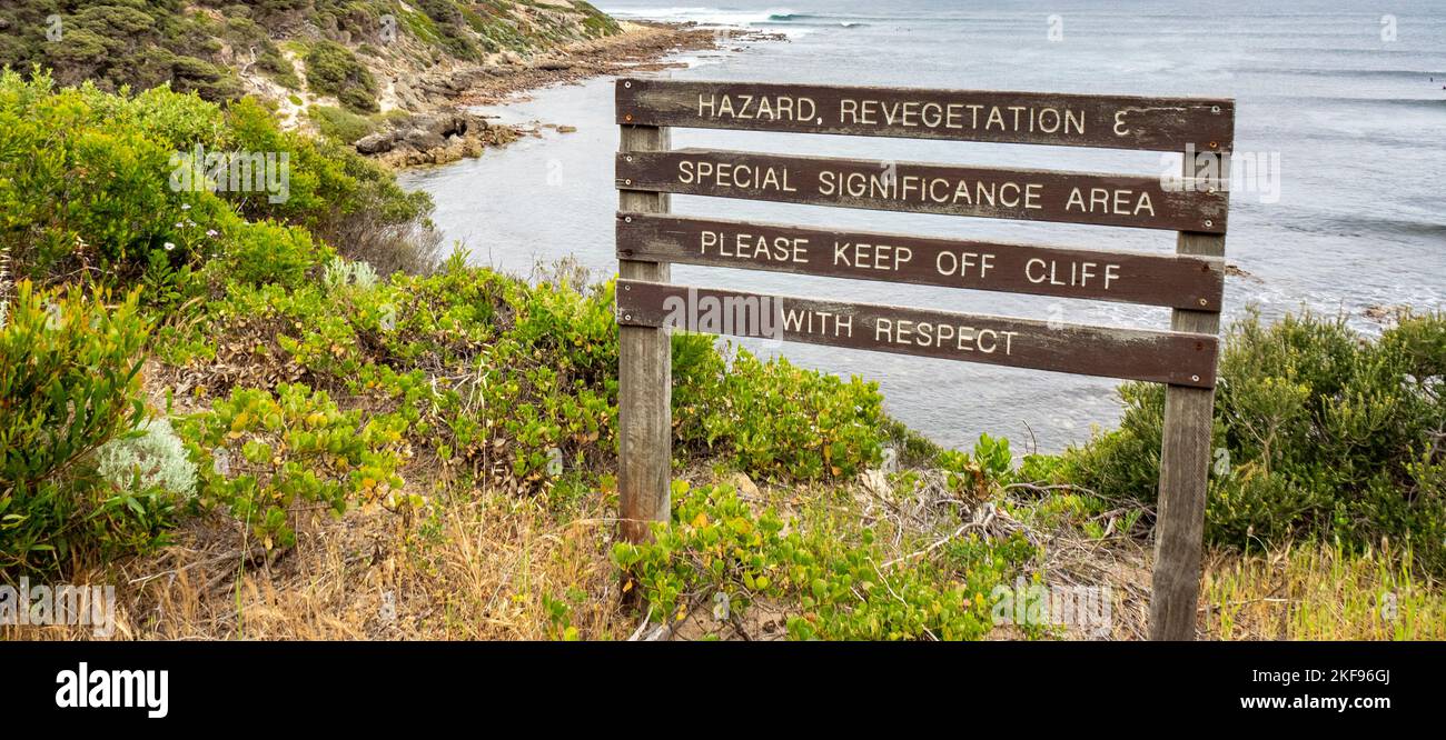 Wooden sign warning of danger near cliff on the Cape to Cape trail ...
