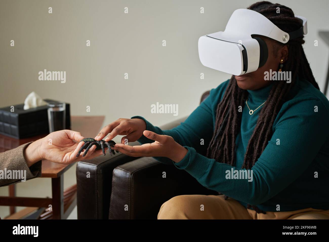 African American girl trying to overcome her phobia of spiders with ...
