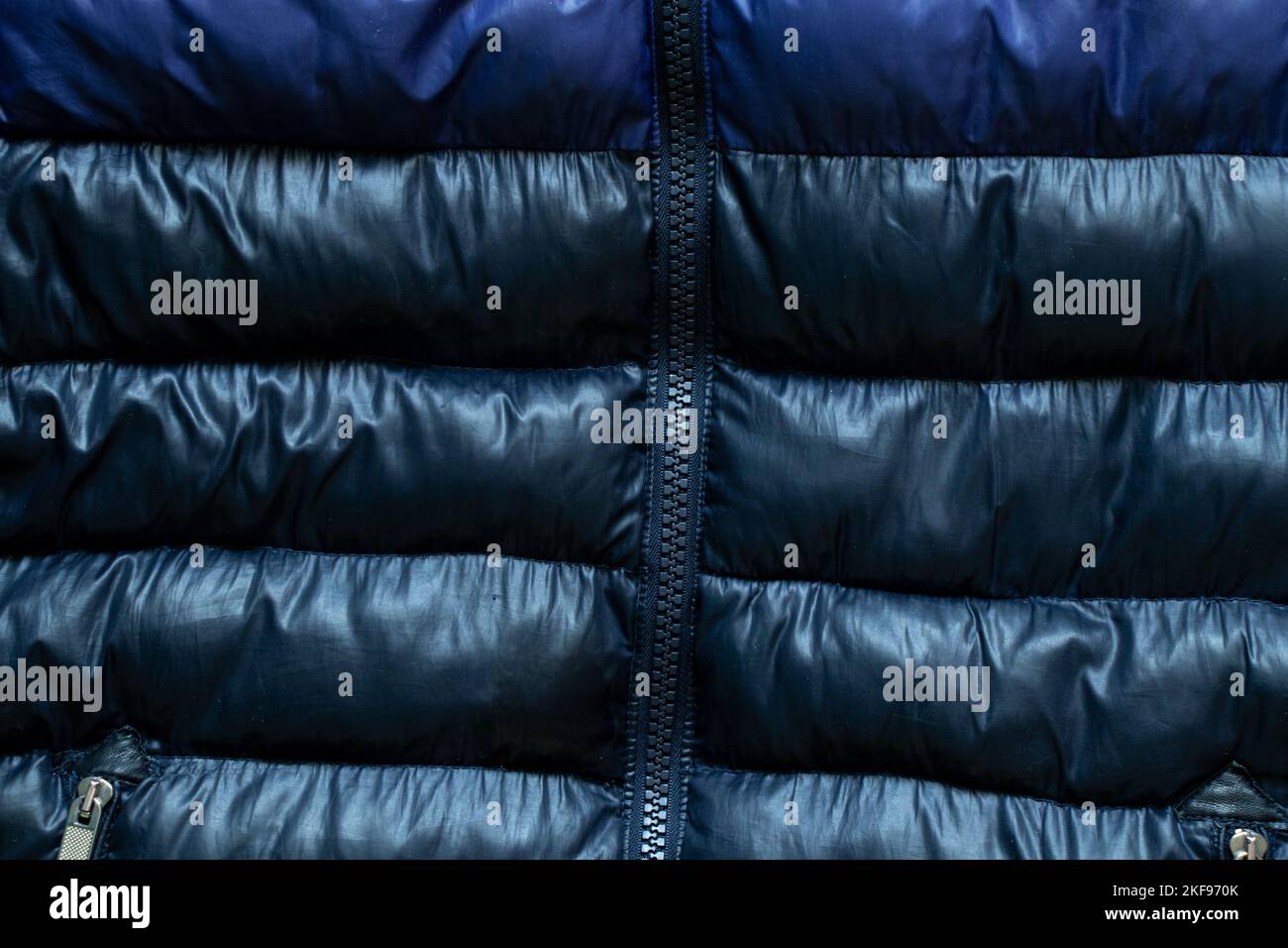 black puffed men's winter jacket as background, down jacket close-up ...