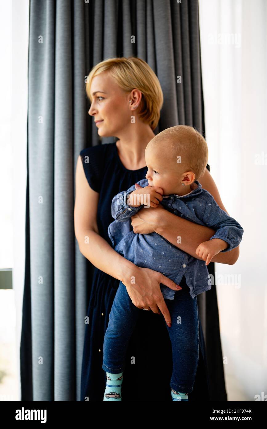 Happy family indoors. Portrait of beautiful mother with cute baby playing smiling together Stock ...