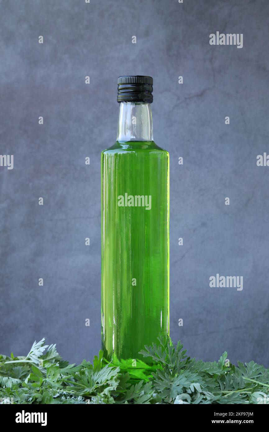 bottle of green absinthe drink on the black background with herbs Stock ...