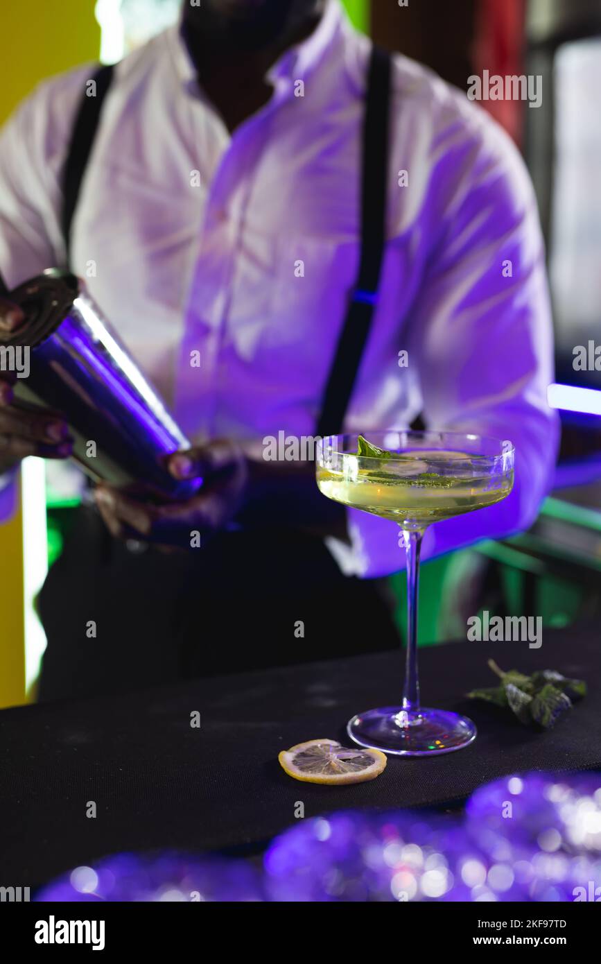 Vertical of midsection of african american barman preparing green ...