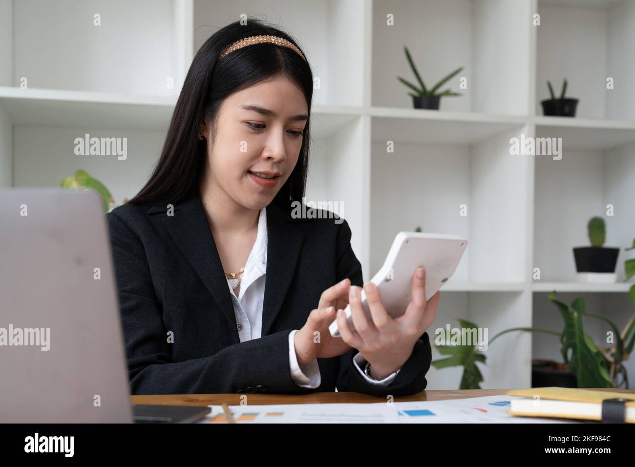 businesswoman accountant working on desk office with using a calculator ...