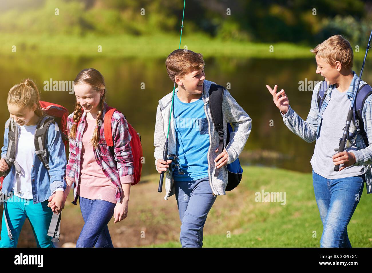 Friends, fun and fresh air. A group of young friends wearing backpacks ...