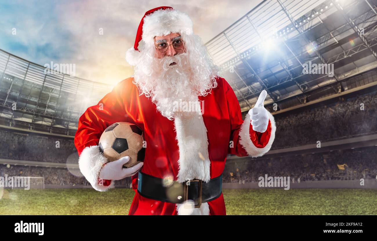 Positive Santa claus with football ball in hand Stock Photo - Alamy