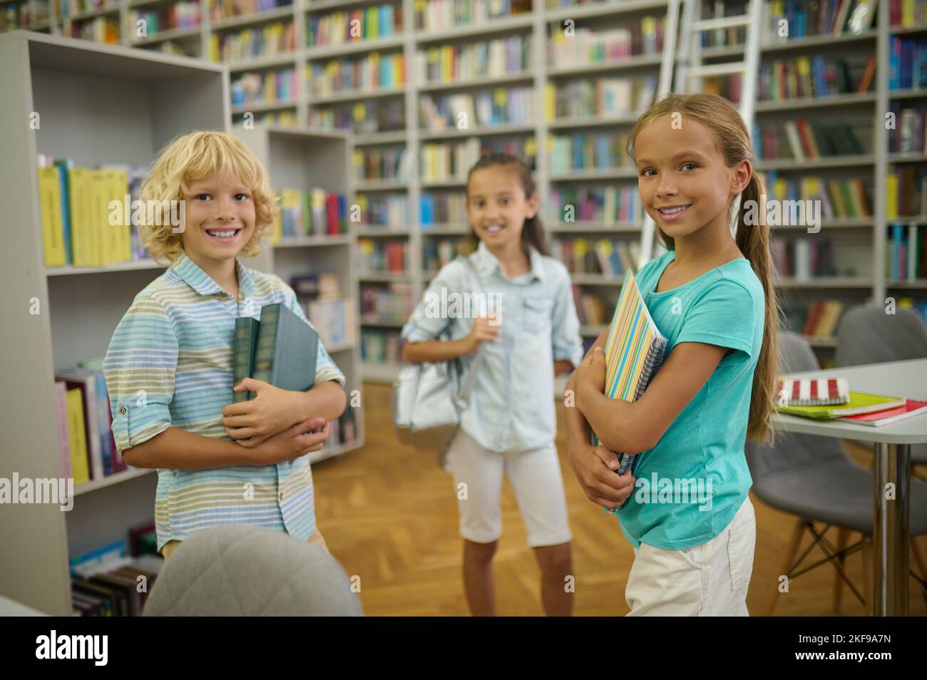 Group of cute kids in the library looking happy and enjoyed Stock Photo ...