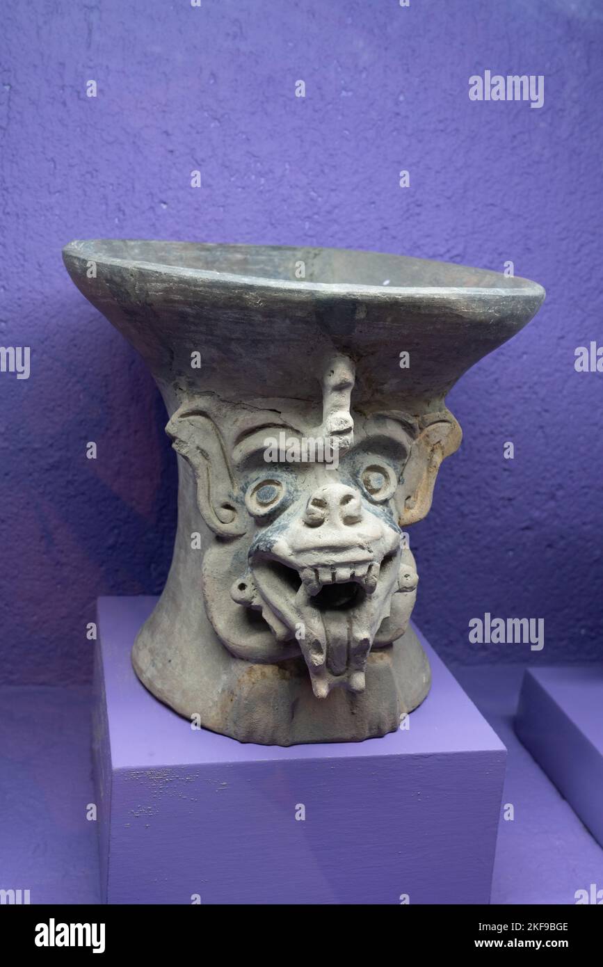 A ceramic incense brazier with a highly stylized face of a monkey ...