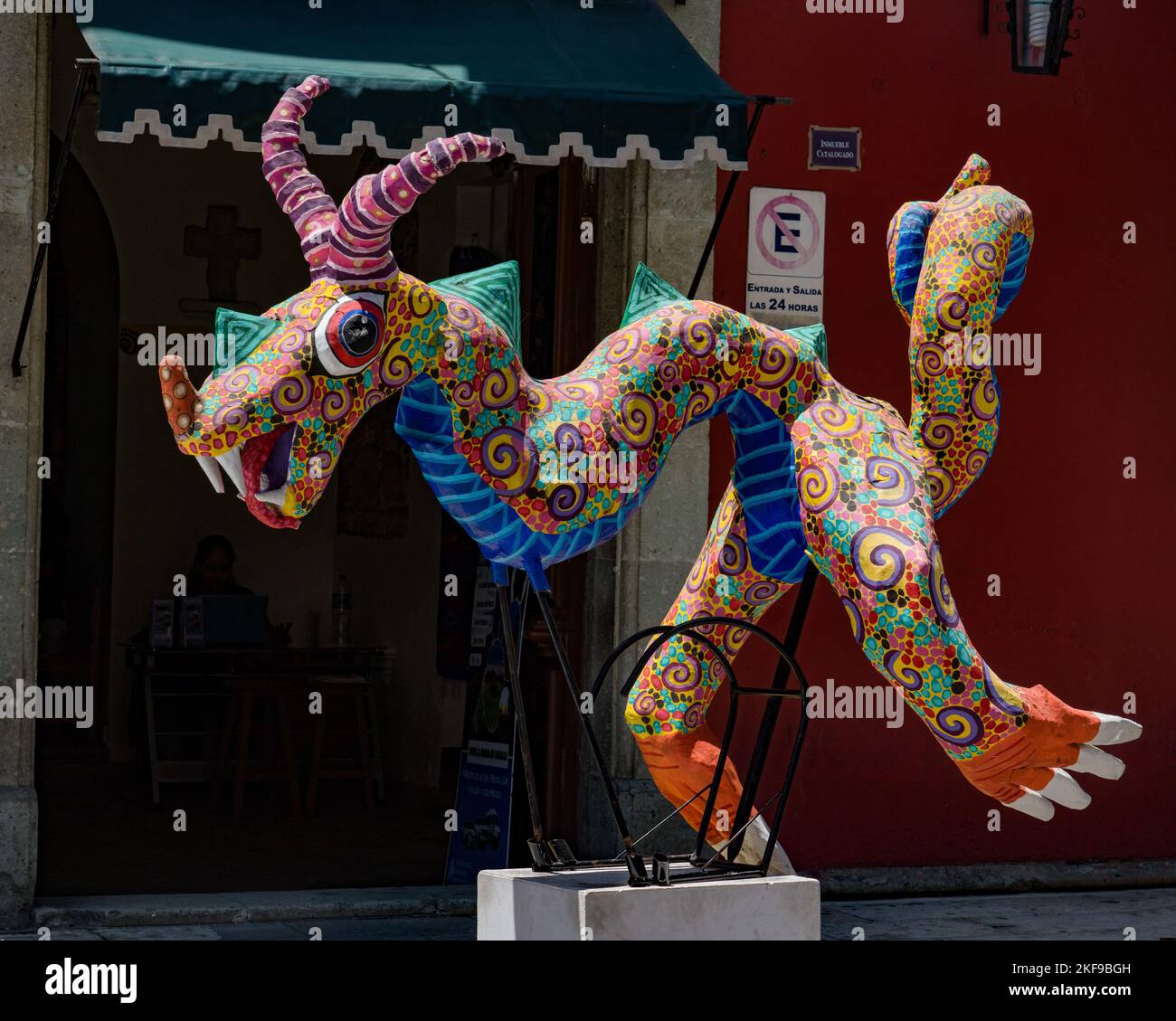 A large papier-mache mythical dragon creature on the street during the ...