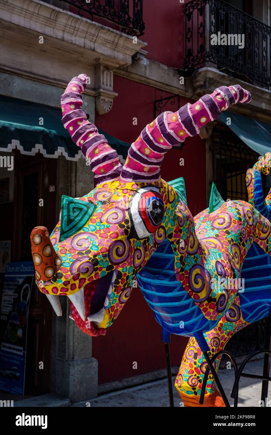 A large papier-mache mythical dragon creature on the street during the ...