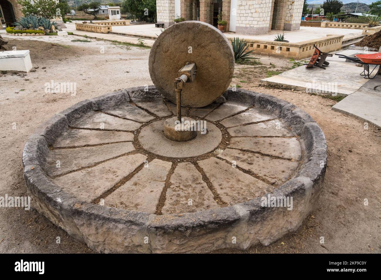 A large stone wheel for crushing the agave hearts after roasting them ...