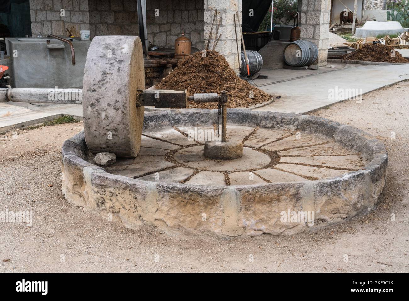 A large stone wheel for crushing the agave hearts after roasting them ...