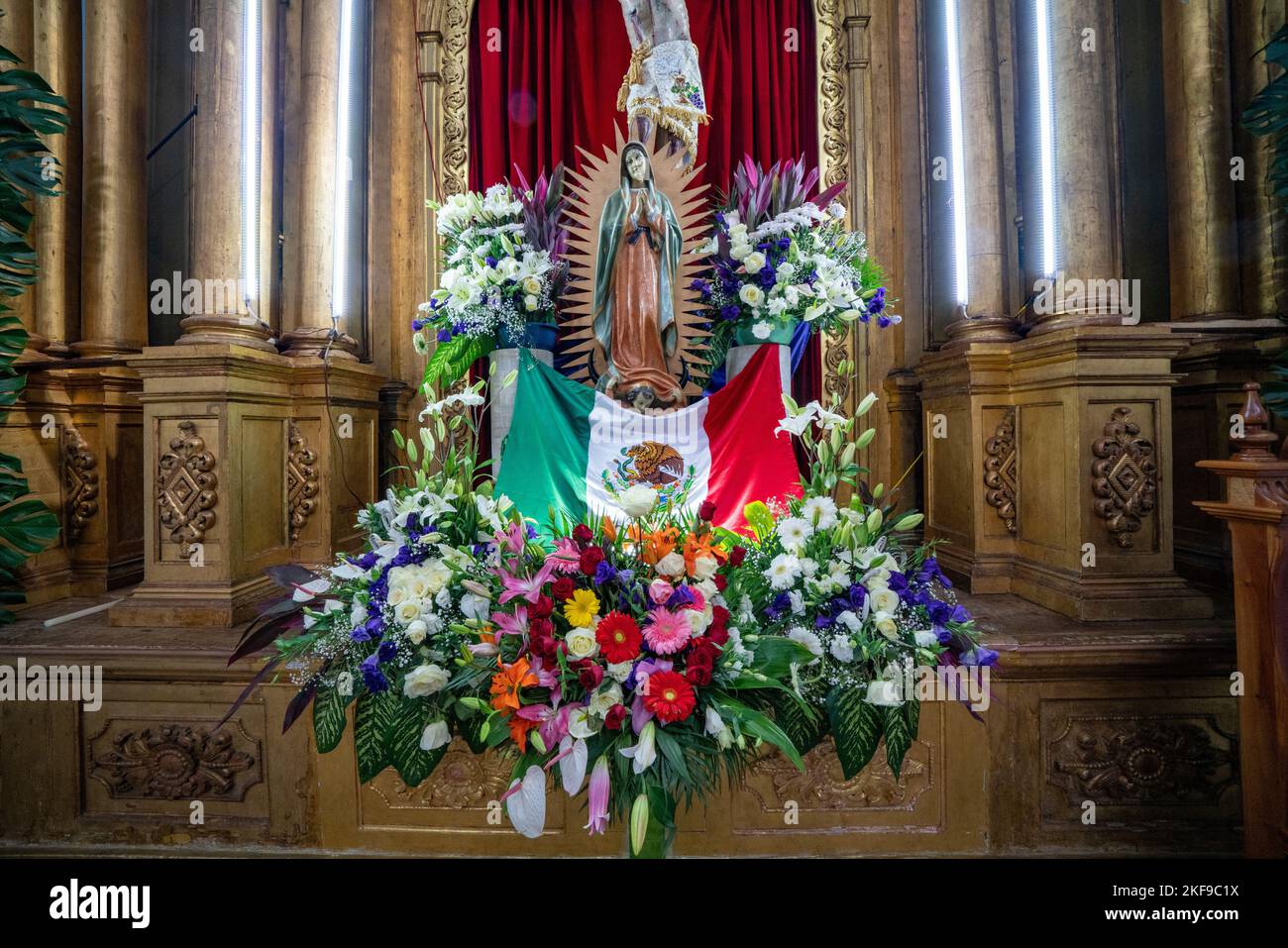 Flowers & statue of the Vrgin Mary in the Church of San Antonino Obisbo ...