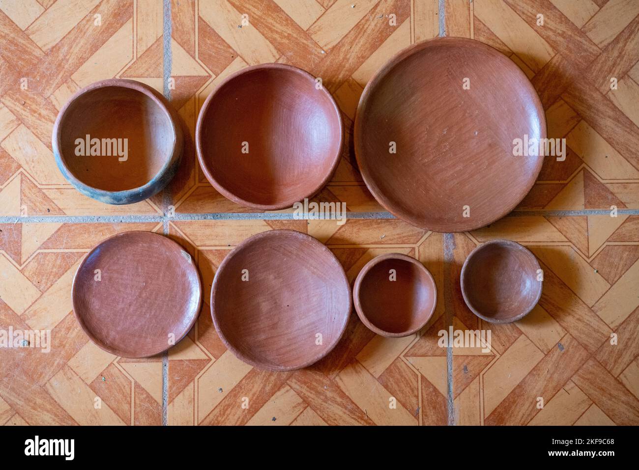 Traditional red clay pottery bowls and dishes made by hand without a ...