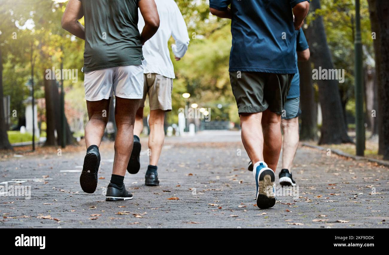 Fitness, men and running club in park, cropped legs in nature for ...