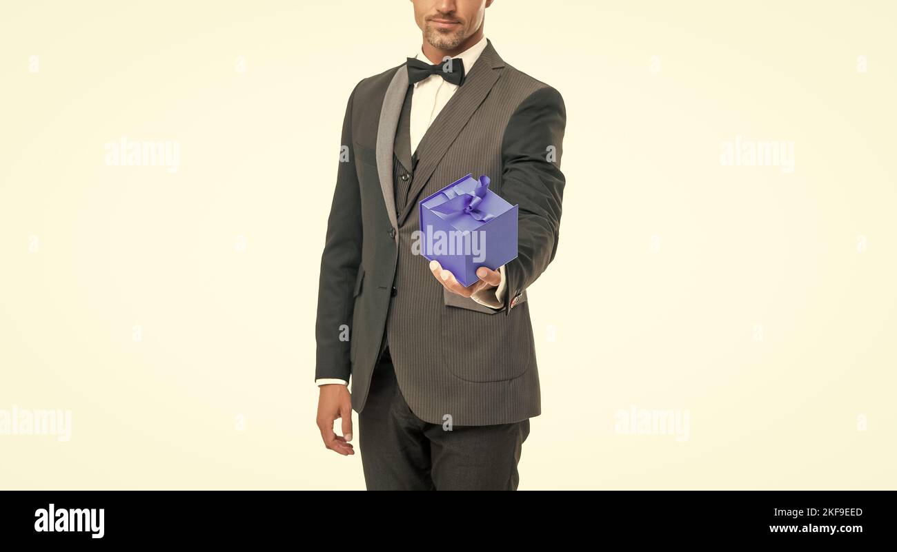 cropped businessman in tuxedo and bow tie hold present box isolated on ...