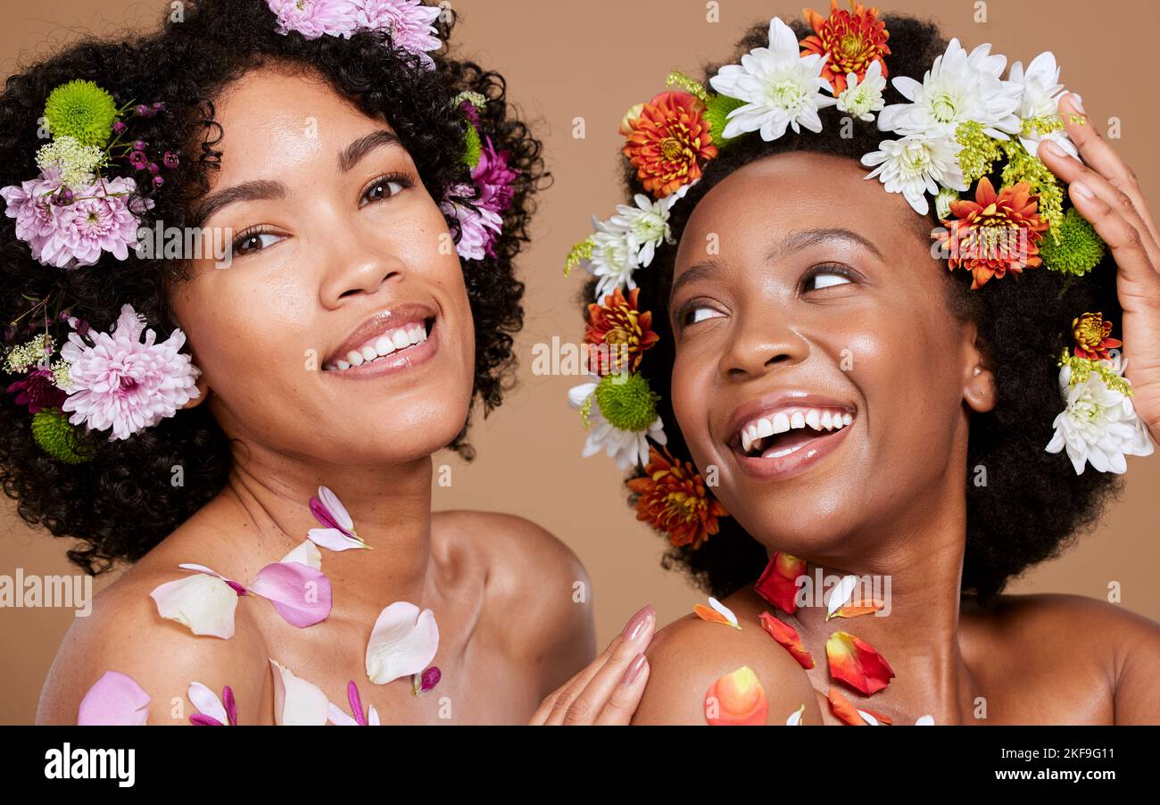 Women, beauty and flowers in studio for wellness, cosmetic and grooming on brown background ...