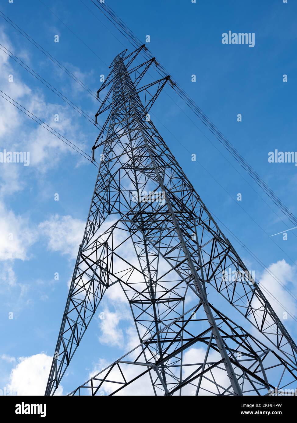 electricity pylon and blue sky with clouds Stock Photo - Alamy