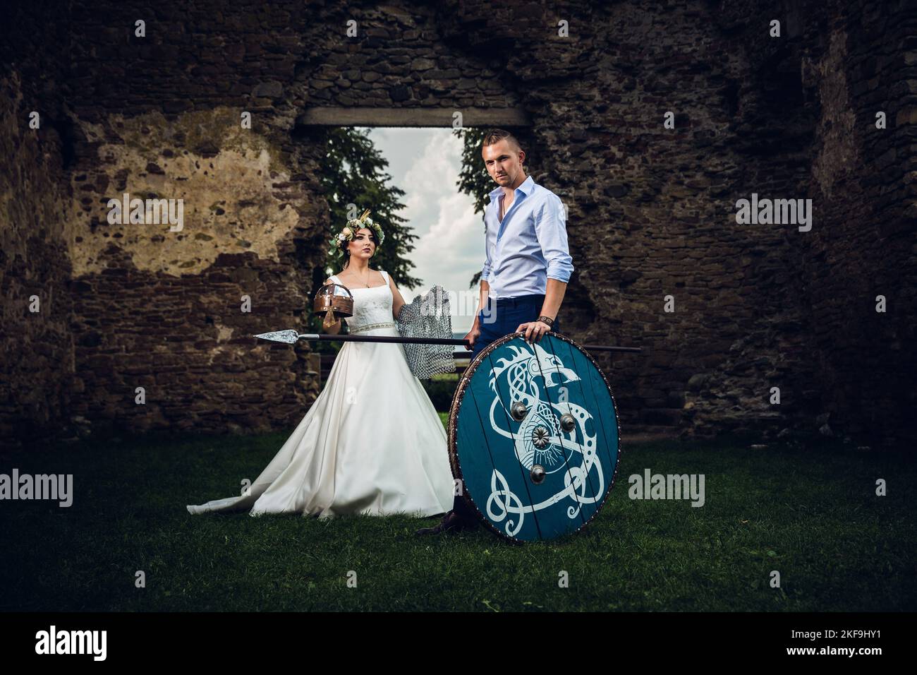 An outdoor portrait of a white Caucasian wedding couple posing with ...
