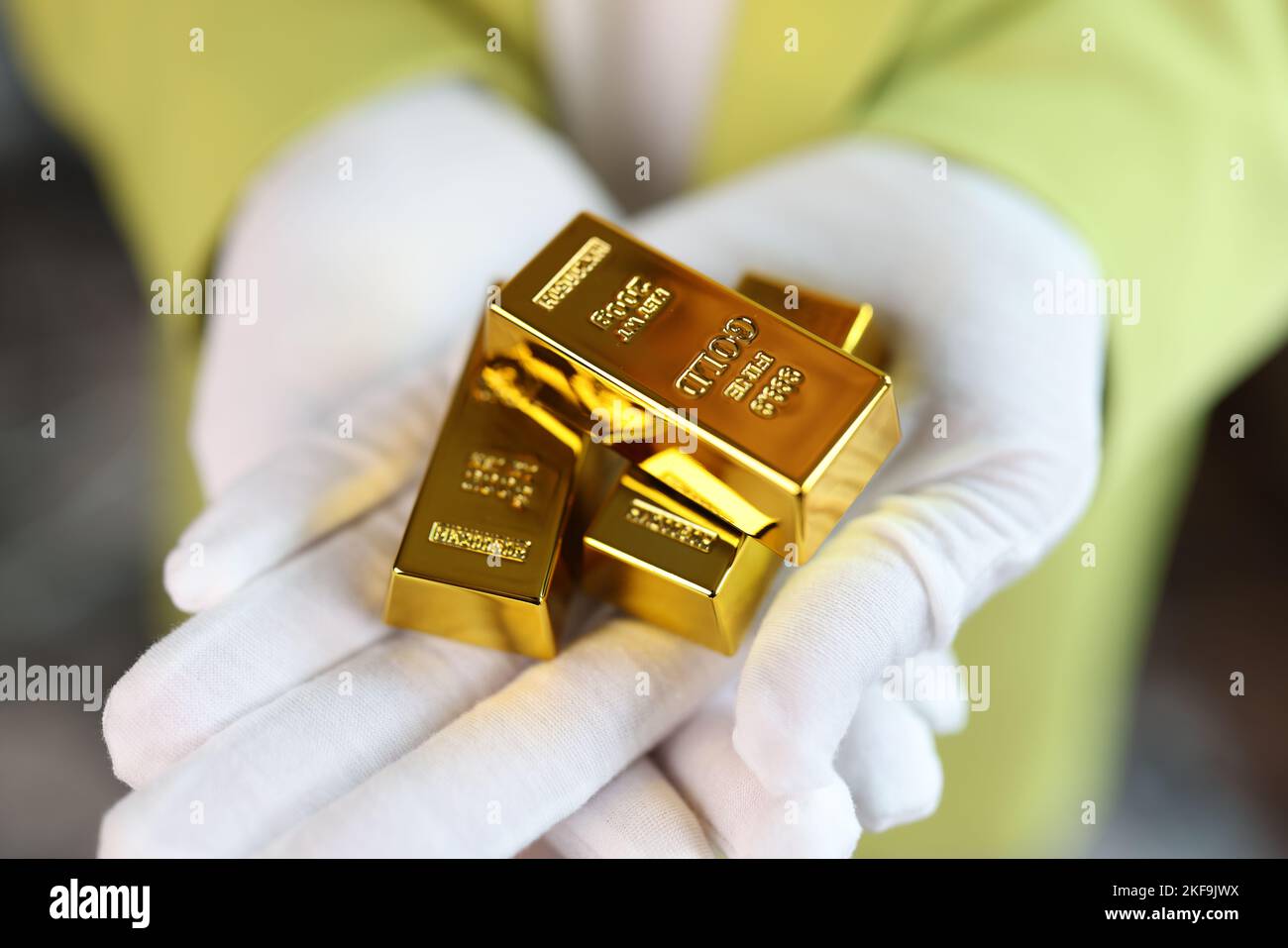 Close-up of man holding gold bars in his hands Stock Photo - Alamy
