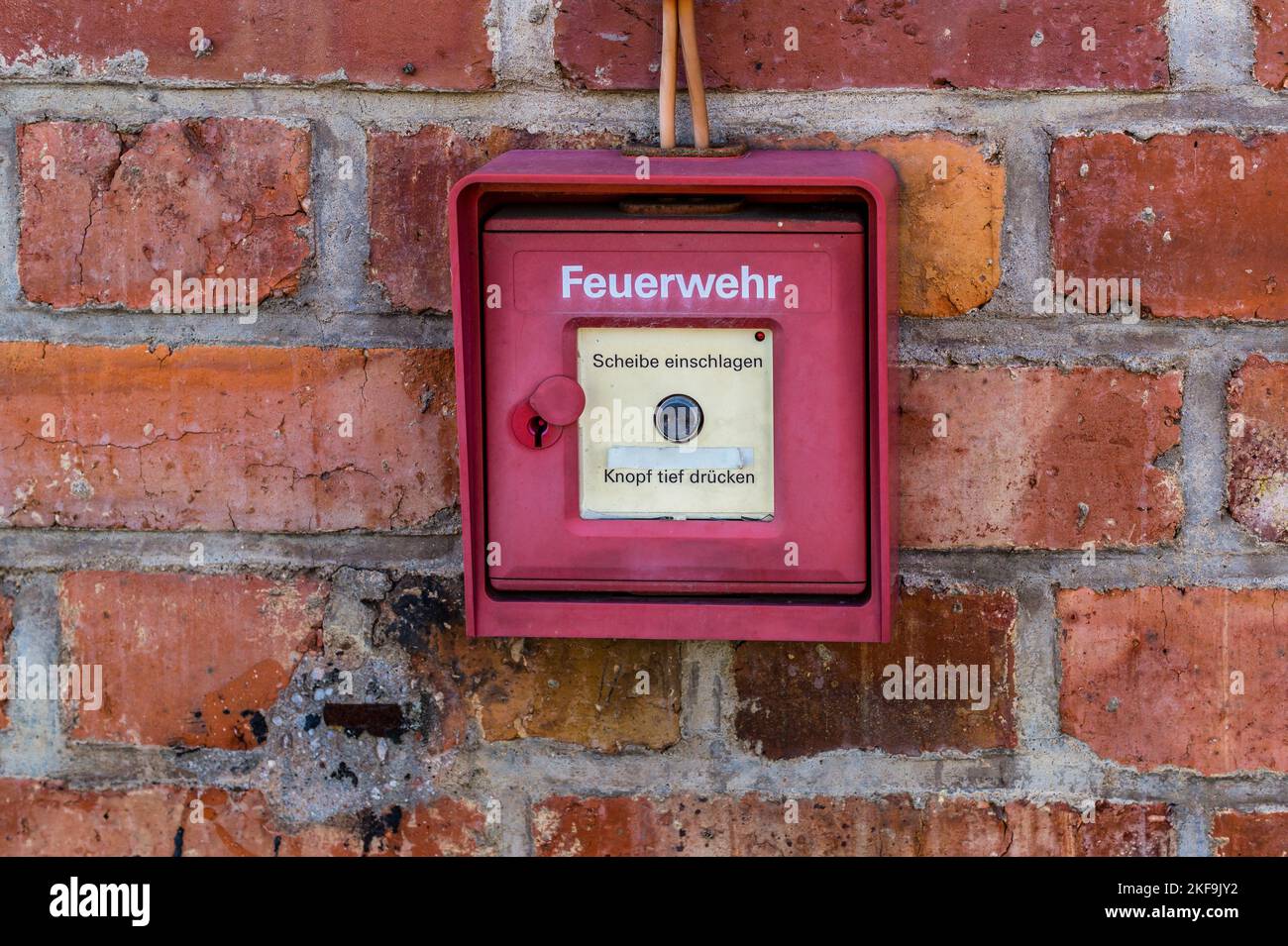 Old German fire alarm on a house wall Stock Photo - Alamy