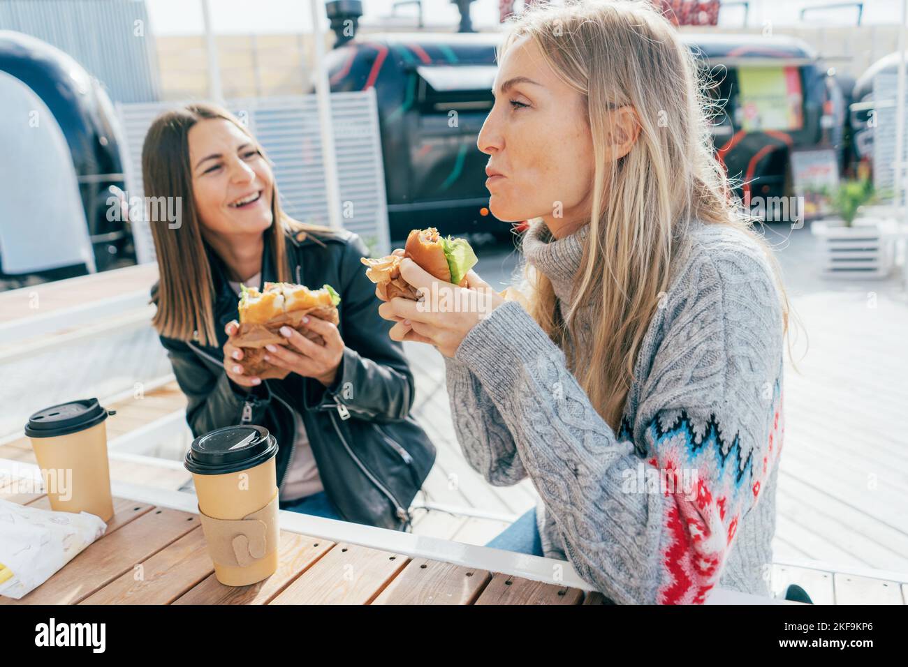 Blonde woman eating burger hi-res stock photography and images - Alamy