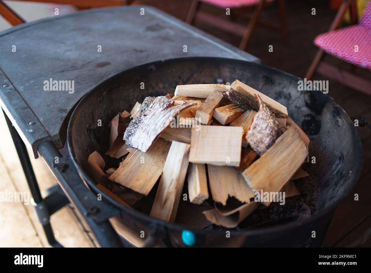 Iron fire pit campfire barbecue place with firewood Stock Photo - Alamy