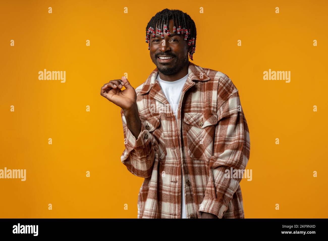 Young african man wearing casual clothes standing on yellow background ...