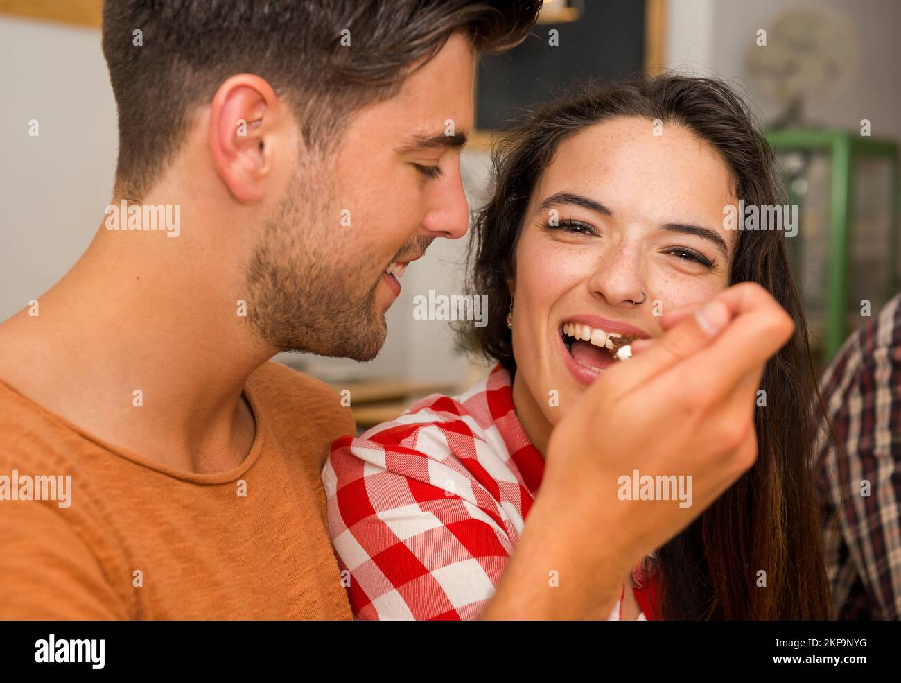 Happy couple at the restaurant and giving food in mouth Stock Photo - Alamy
