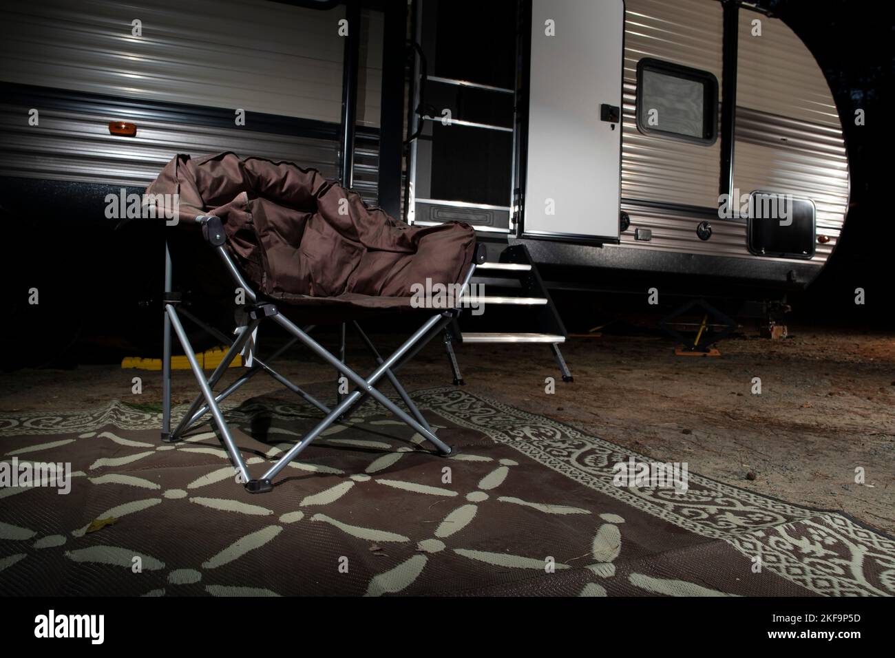 Empty campsite chair with RV behing at Jordan Lake in North Carolina ...