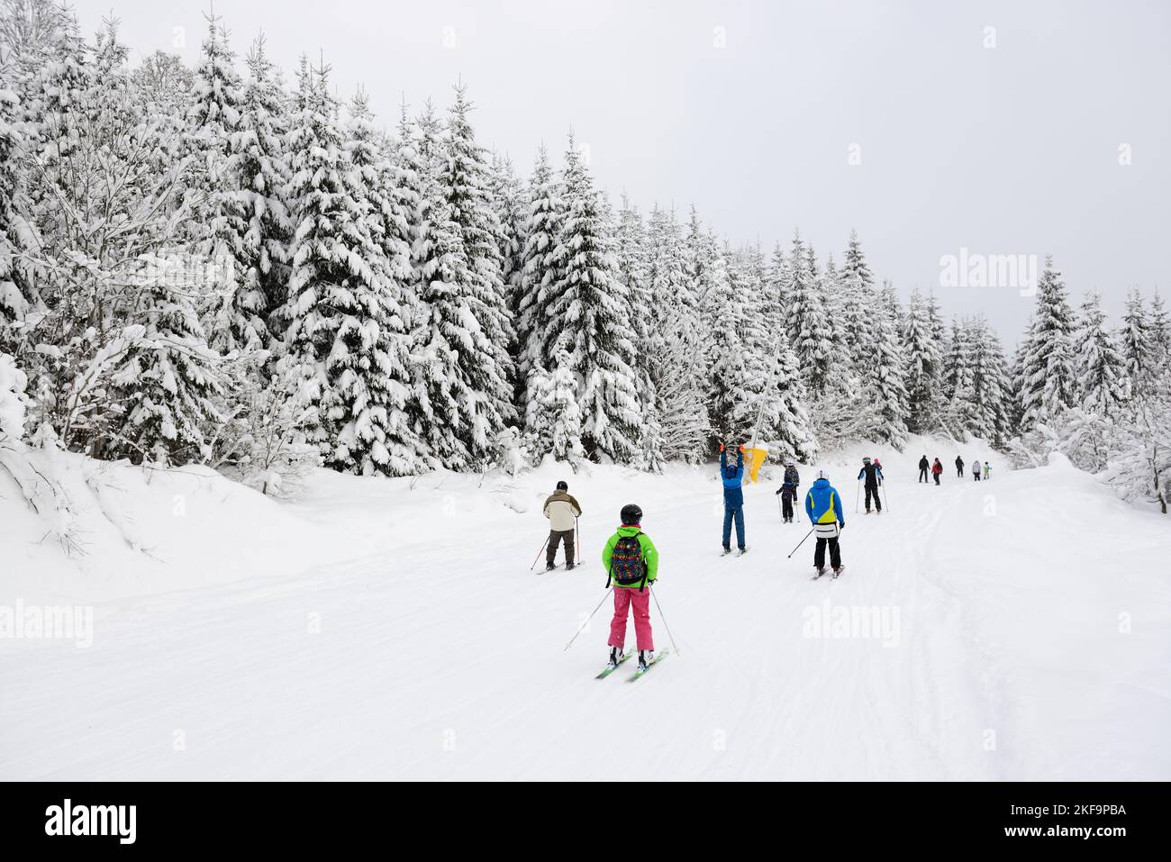 BUKOVEL, UKRAINE - DECEMBER 25: The skiers and snowborders are on slope ...